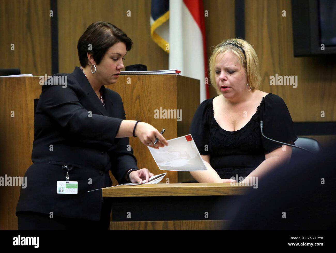 Assistant district attorney Sally Kirby-Turner shows photos to witness ...