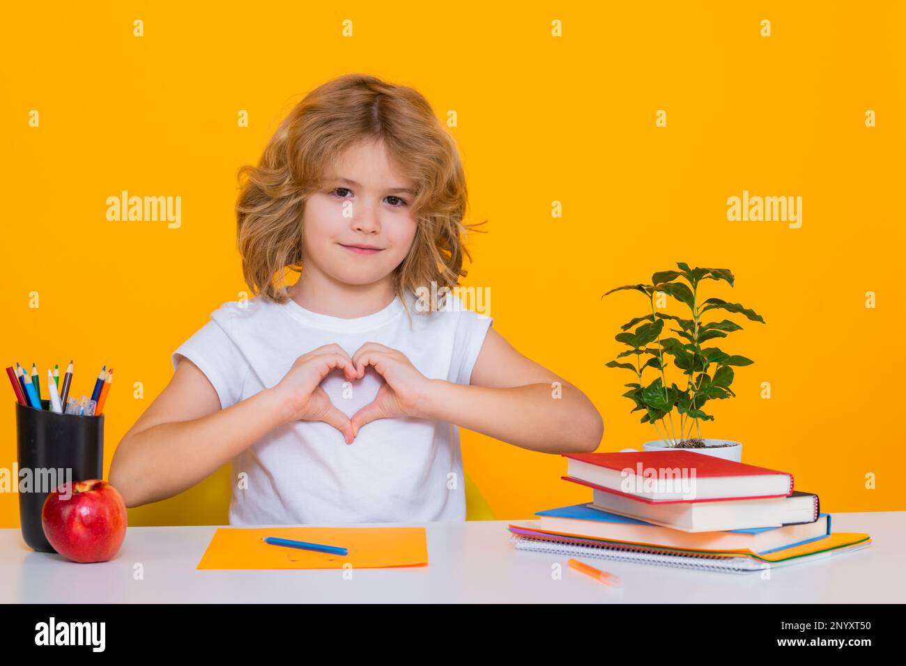 Pupil with love heard sign. Nerd pupil boy from elementary school with ...