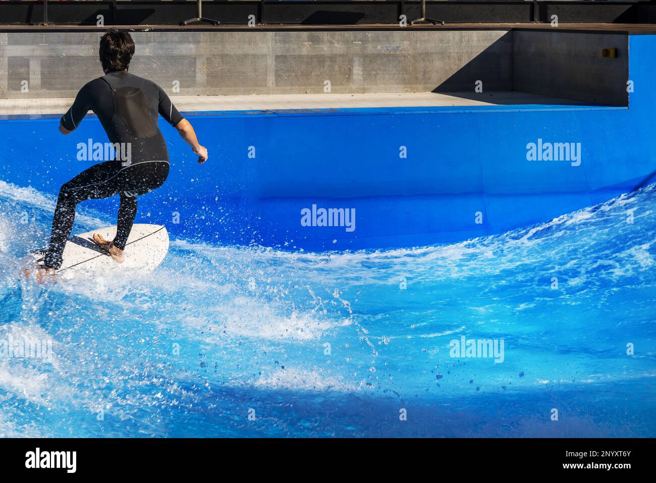 A surfer enjoying the waves provided by an urban wave pool Stock Photo ...