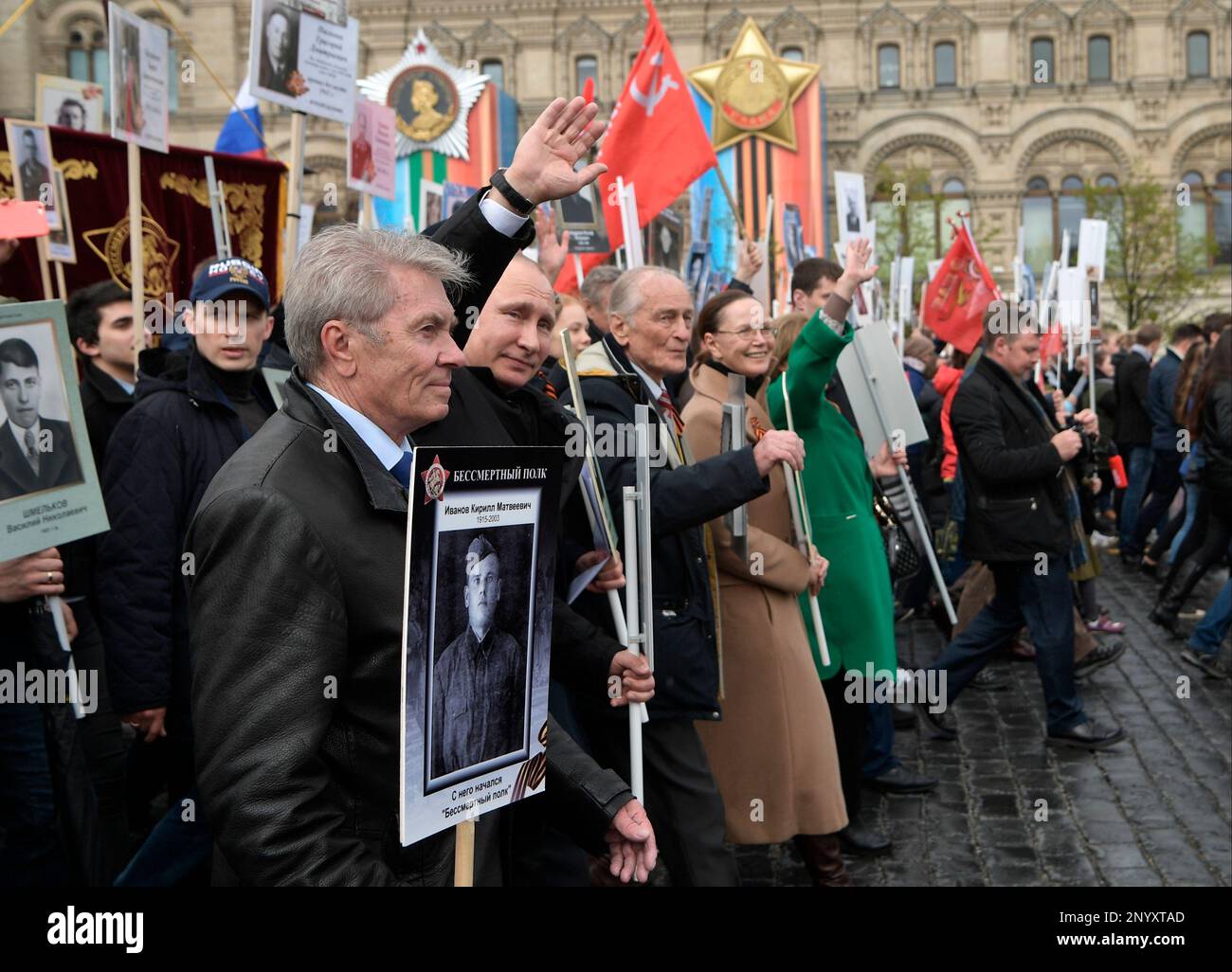 Russian President Vladimir Putin, foreground second left, waves while ...