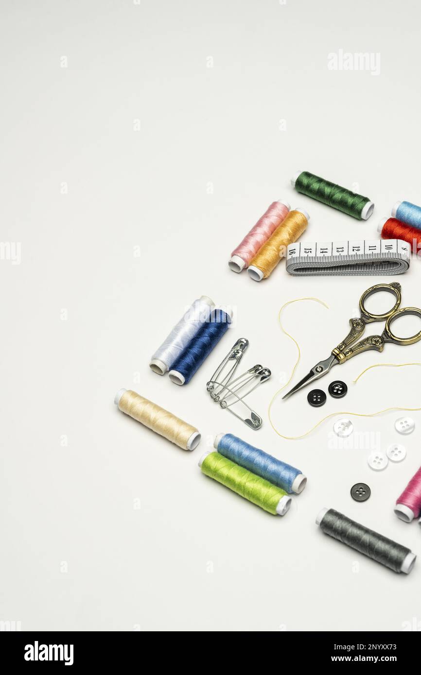 Still life with golden vintage sewing scissors on a plain white surface ...