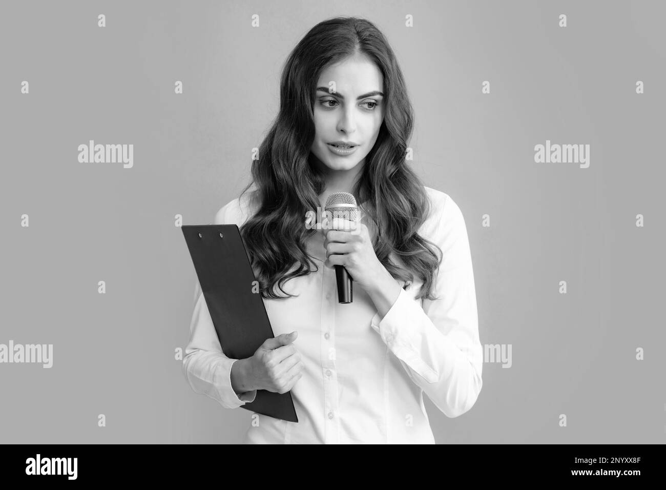 Beautiful business woman is speaking on conference. Microphone speech ...