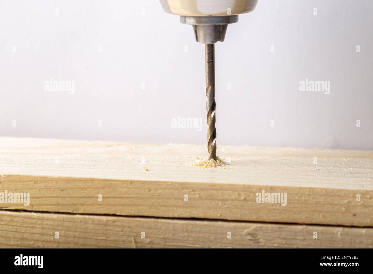 Close-up of a drill bit making a hole in wood Stock Photo - Alamy