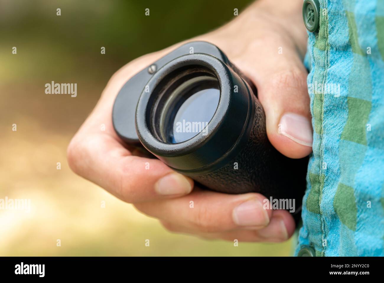 Man holding a simple magnifying monocular glass, modern spy spyglass in ...