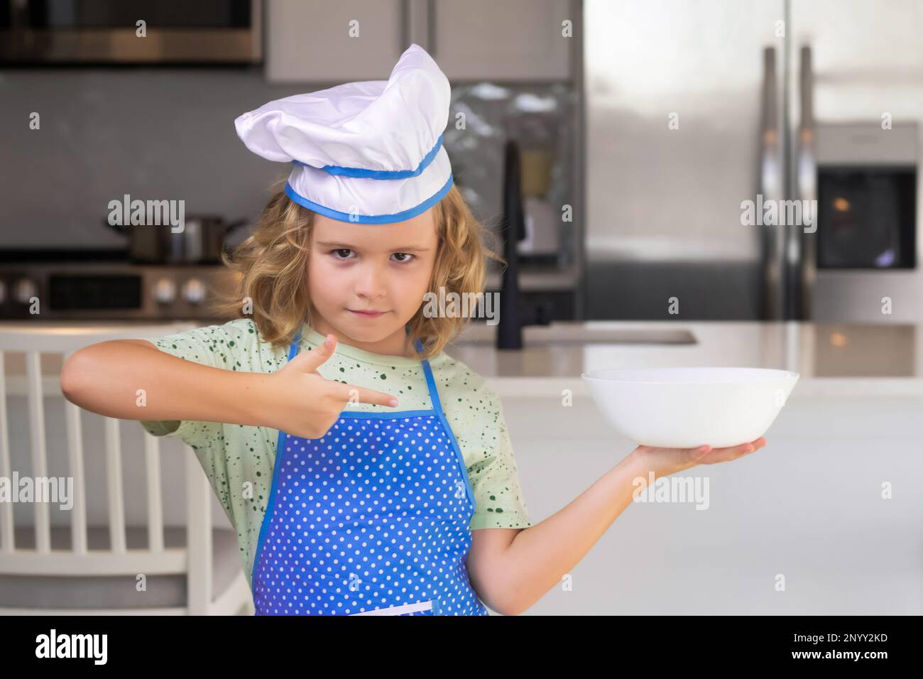 Children cooking in the kitchen. Funny kid chef cook cookery at kitchen ...