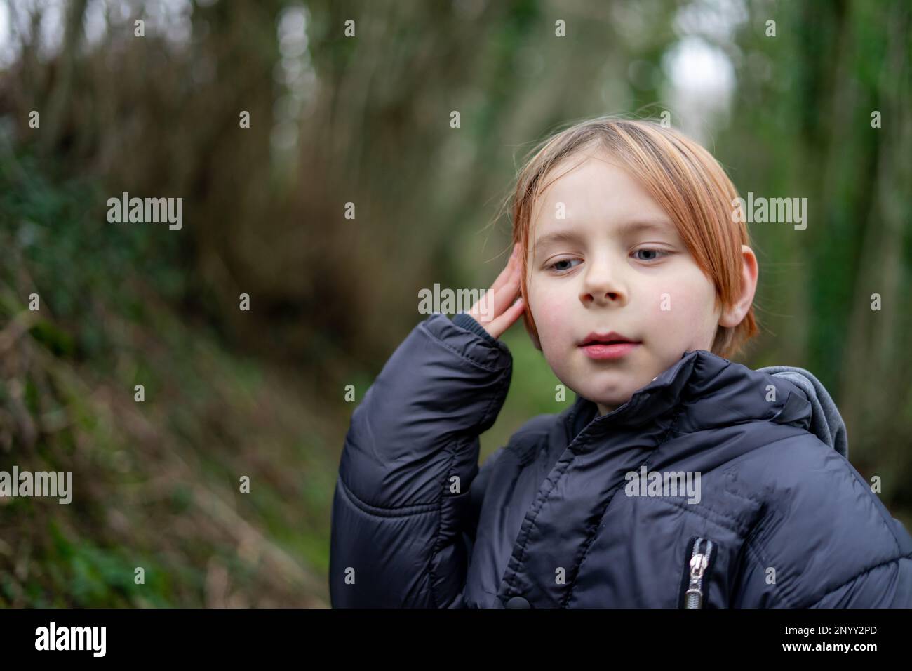 Young boy in outdoors thoughtfulness. A boy of eight ten years old in a ...