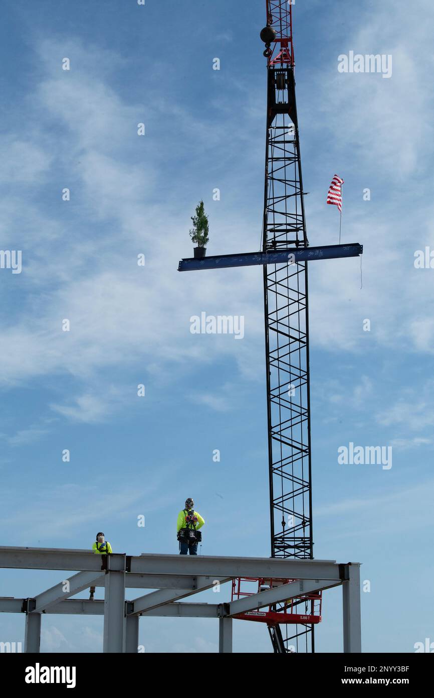 Steelworkers wait to secure the ceremonial final beam to the future ...