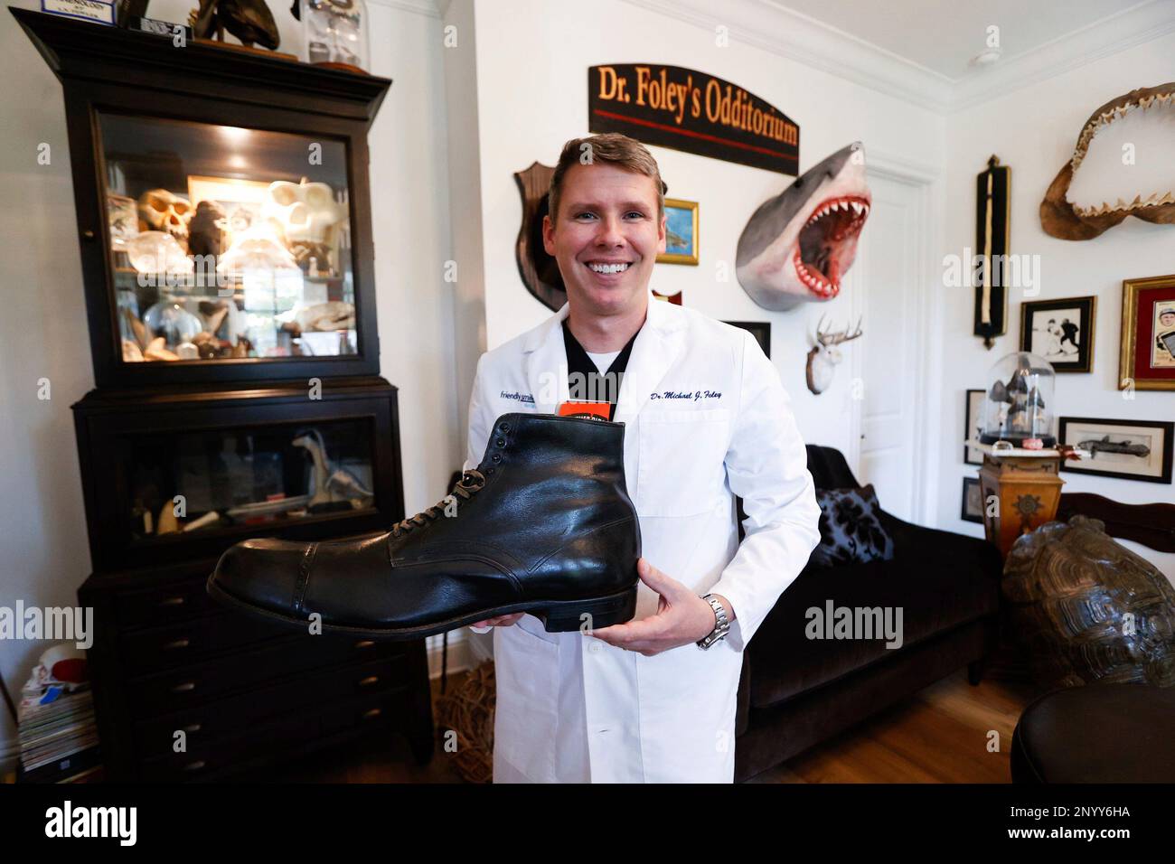 Dentist Mike Foley holds a shoe worn by Robert Wadlow, the world's ...
