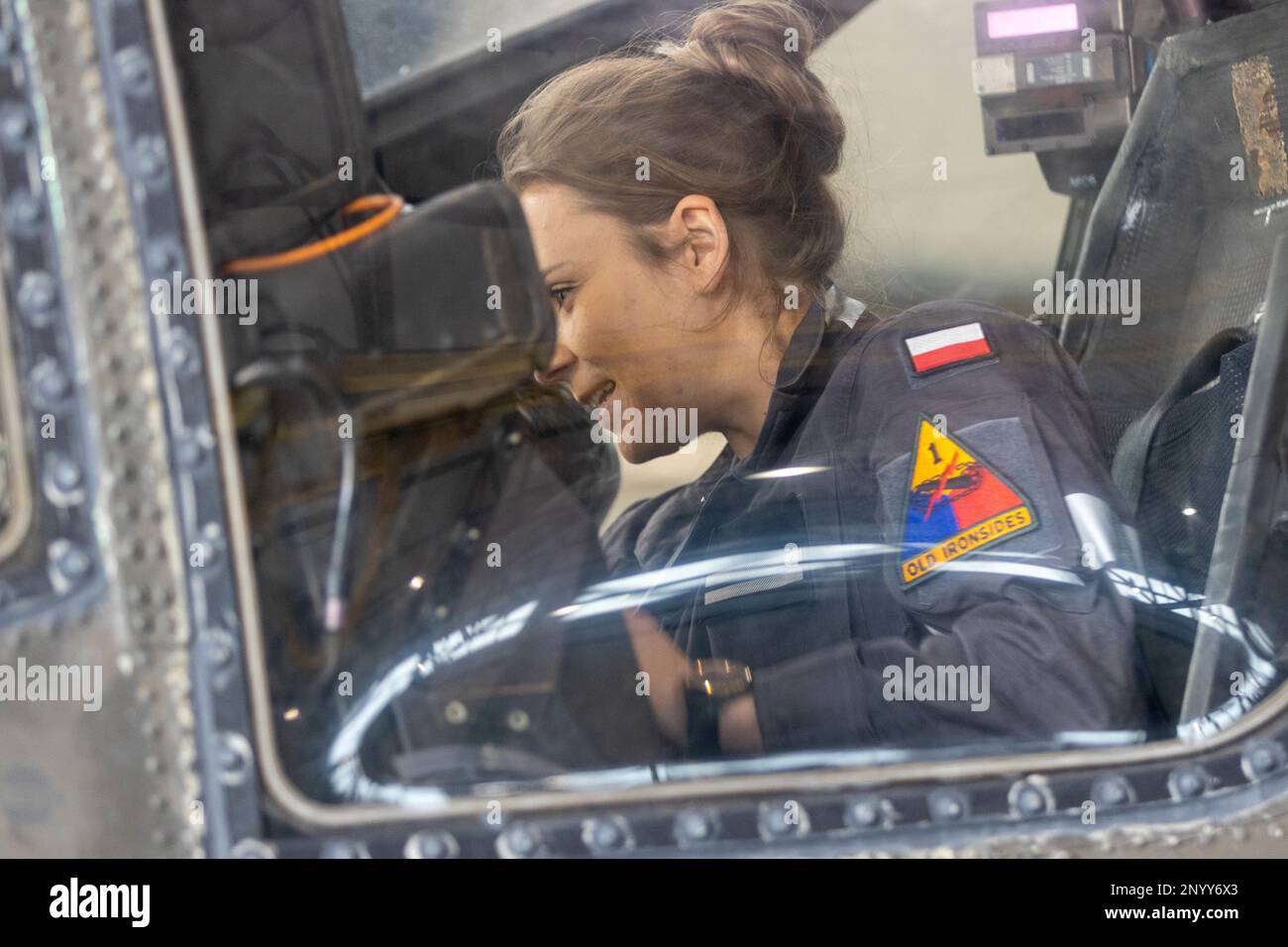 A Polish Soldier looks inside an AH-64 Apache assigned to 3-6 Air ...