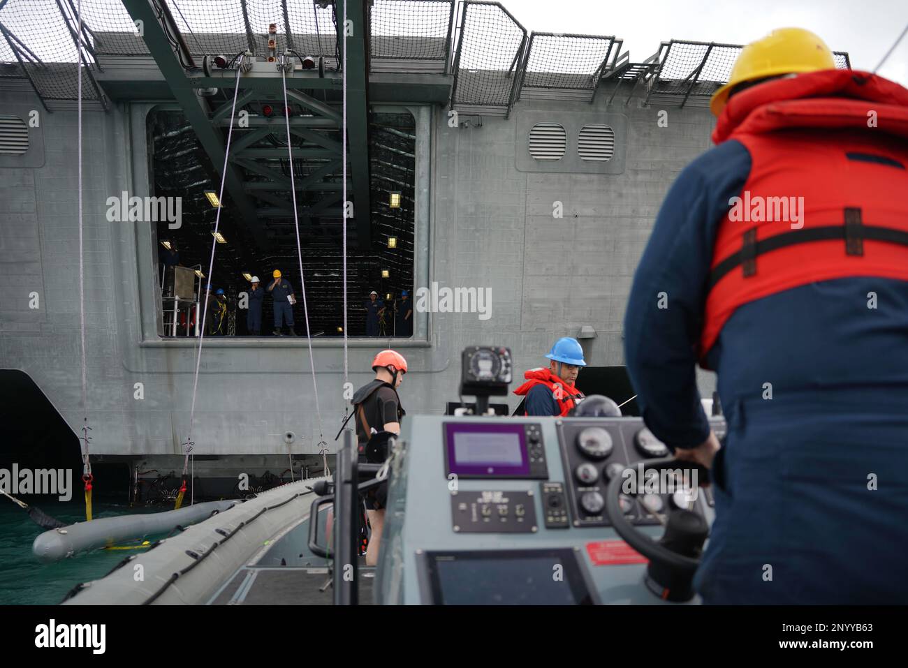 SINGAPORE (Jan. 30, 2023) Sailors operate a twin boom extendable crane ...