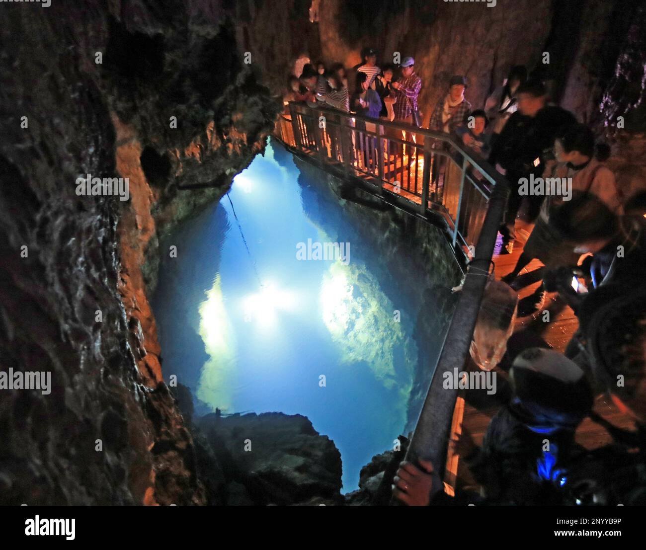 A group of travelers view the Ryusendo, one of Japan's three biggest ...