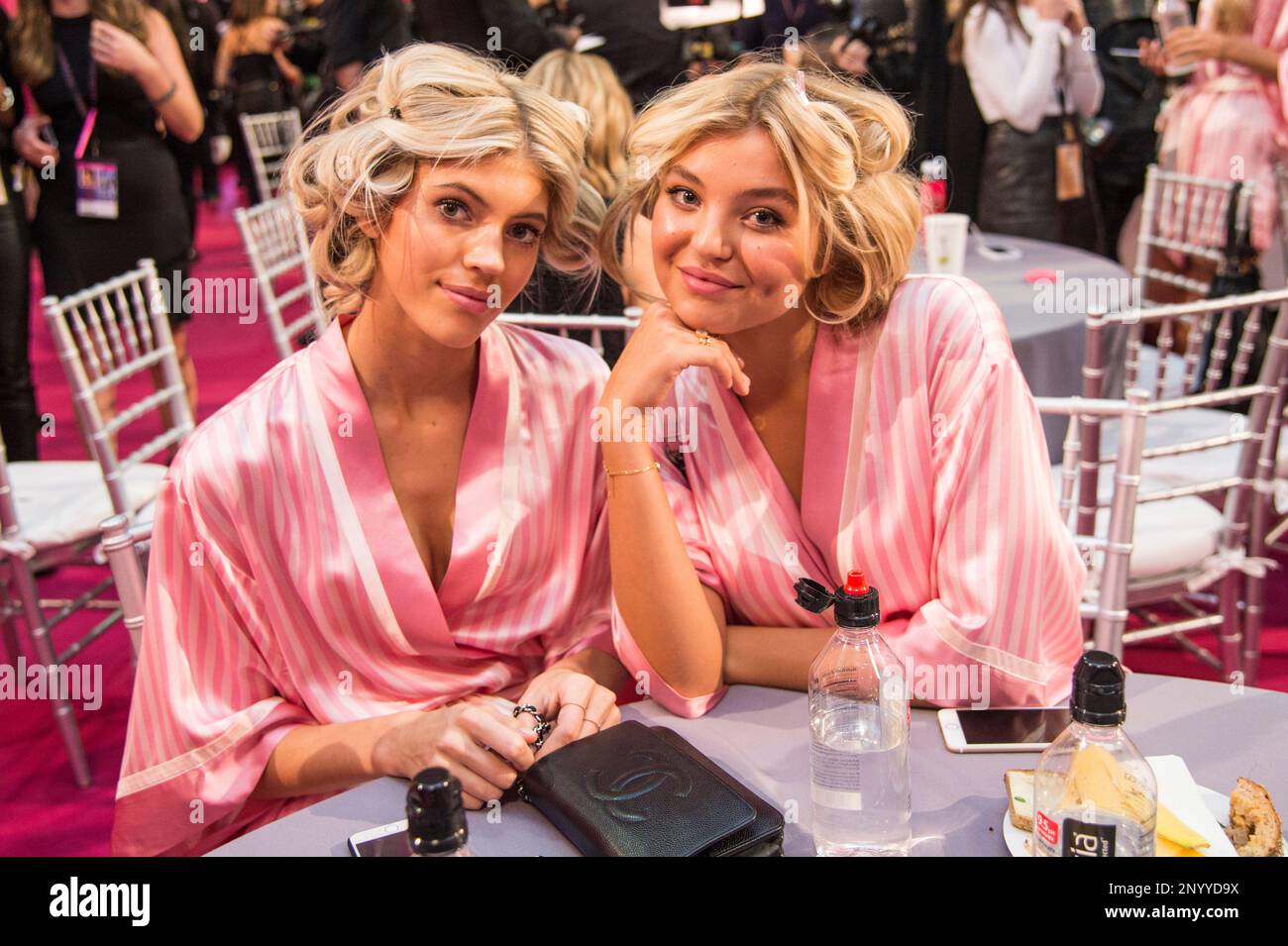 Models Rachel Hilbert and Devon Windsor prepare backstage before the ...