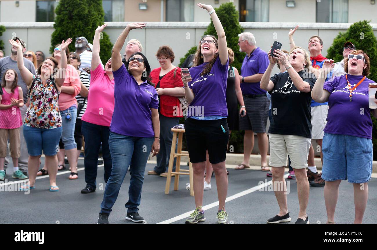 Spectators cheer as rapellers make their way down the Aloft Winchester ...
