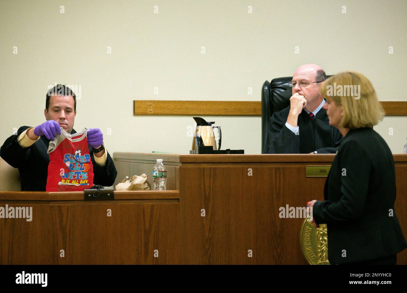 Detective William Rumell, left, holds the pajama top of victim Brendan ...