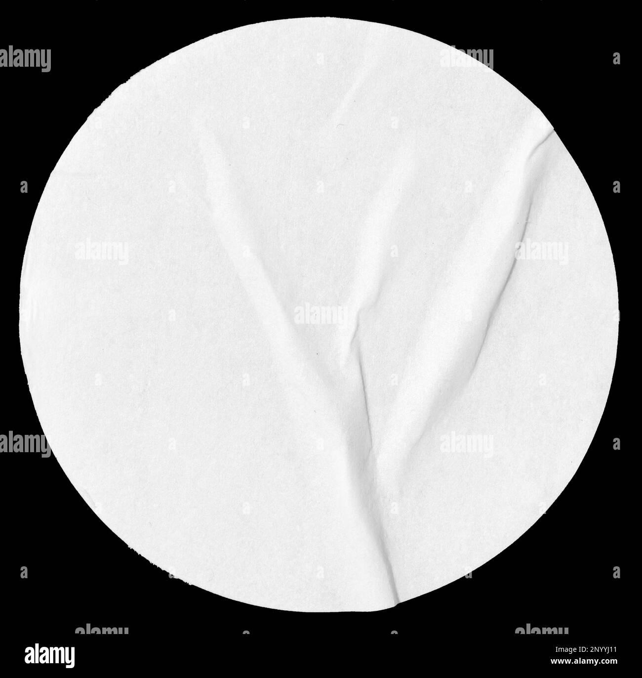 Blank white circle shape label isolated on black background. Crumpled ...