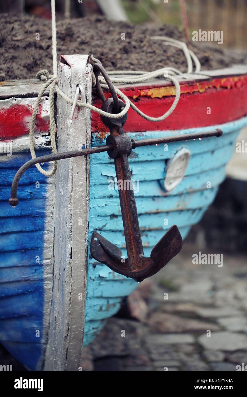 Old blue and red boat with black anchor Stock Photo - Alamy