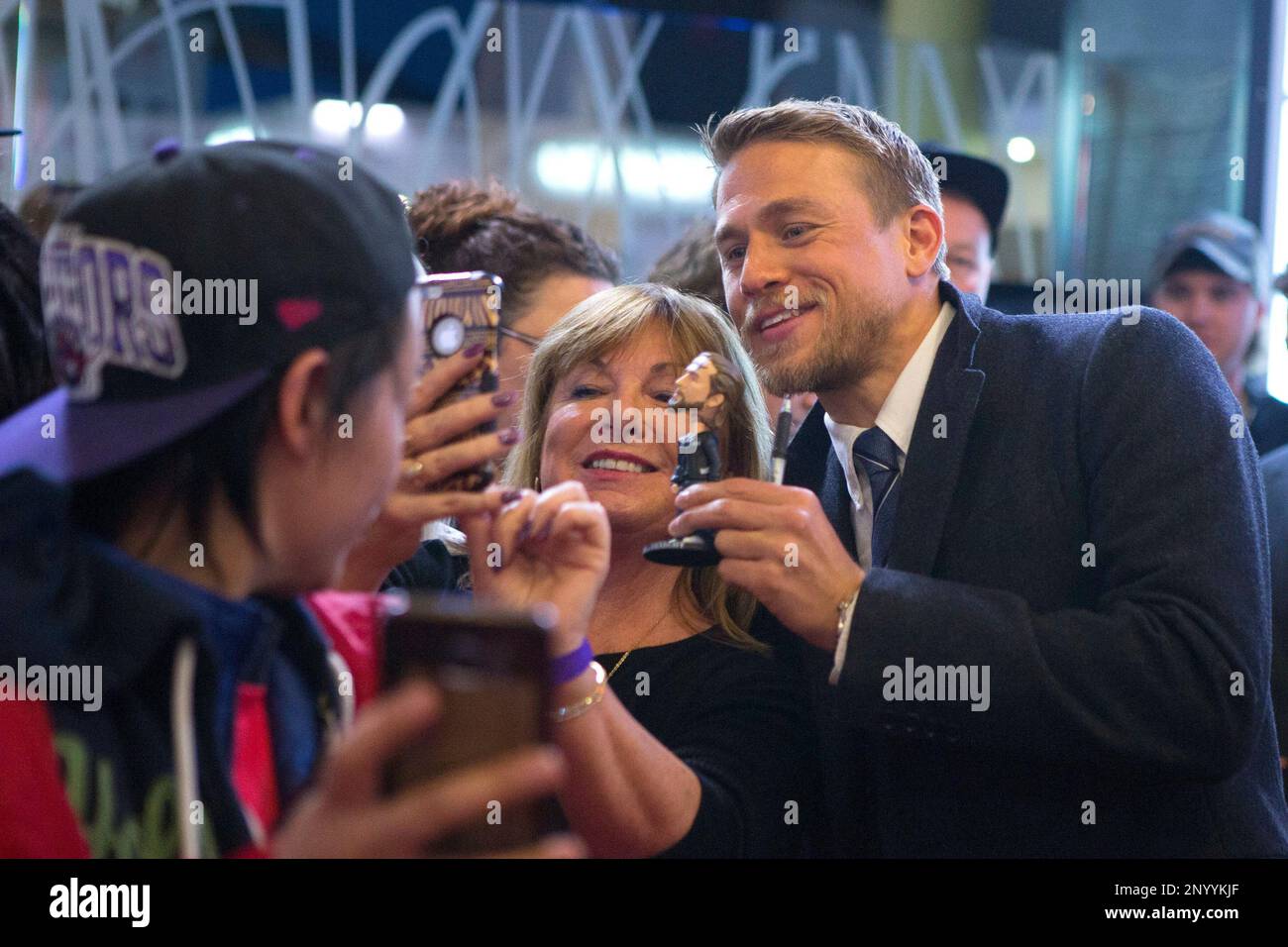 Actor Charlie Hunnam greets fans as he arrives on the red carpet as he ...
