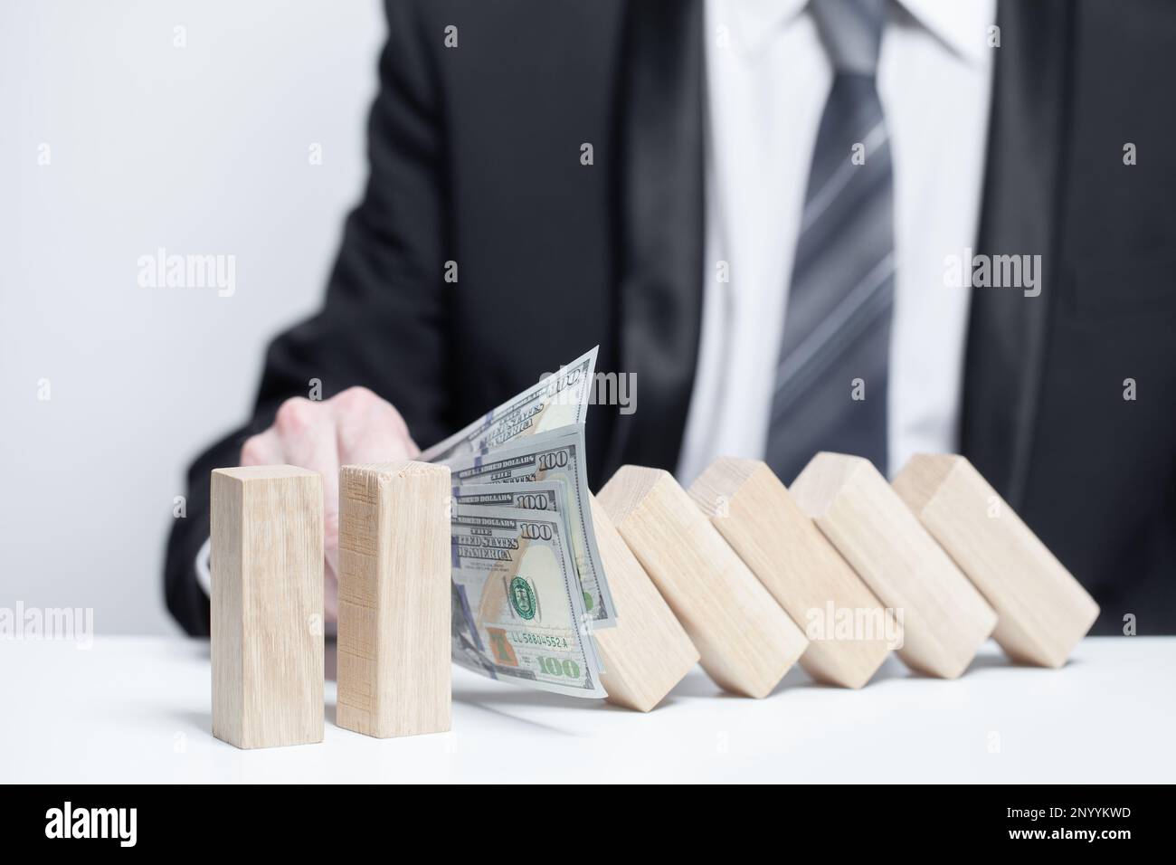 Wooden blocks under money us dollars protection, domino, insurance ...