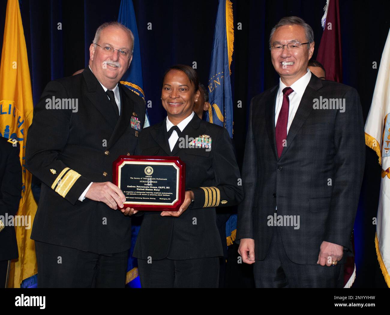 U.S. Navy Capt. Andrea Petrovanie-Green is presented with the AMSUS ...