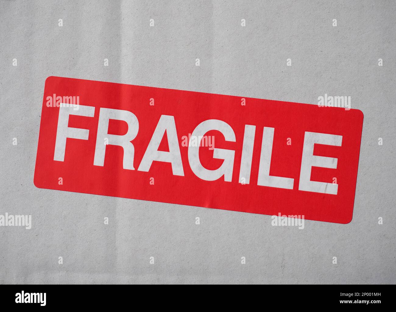 fragile warning sign label tag on a cardboard box Stock Photo - Alamy