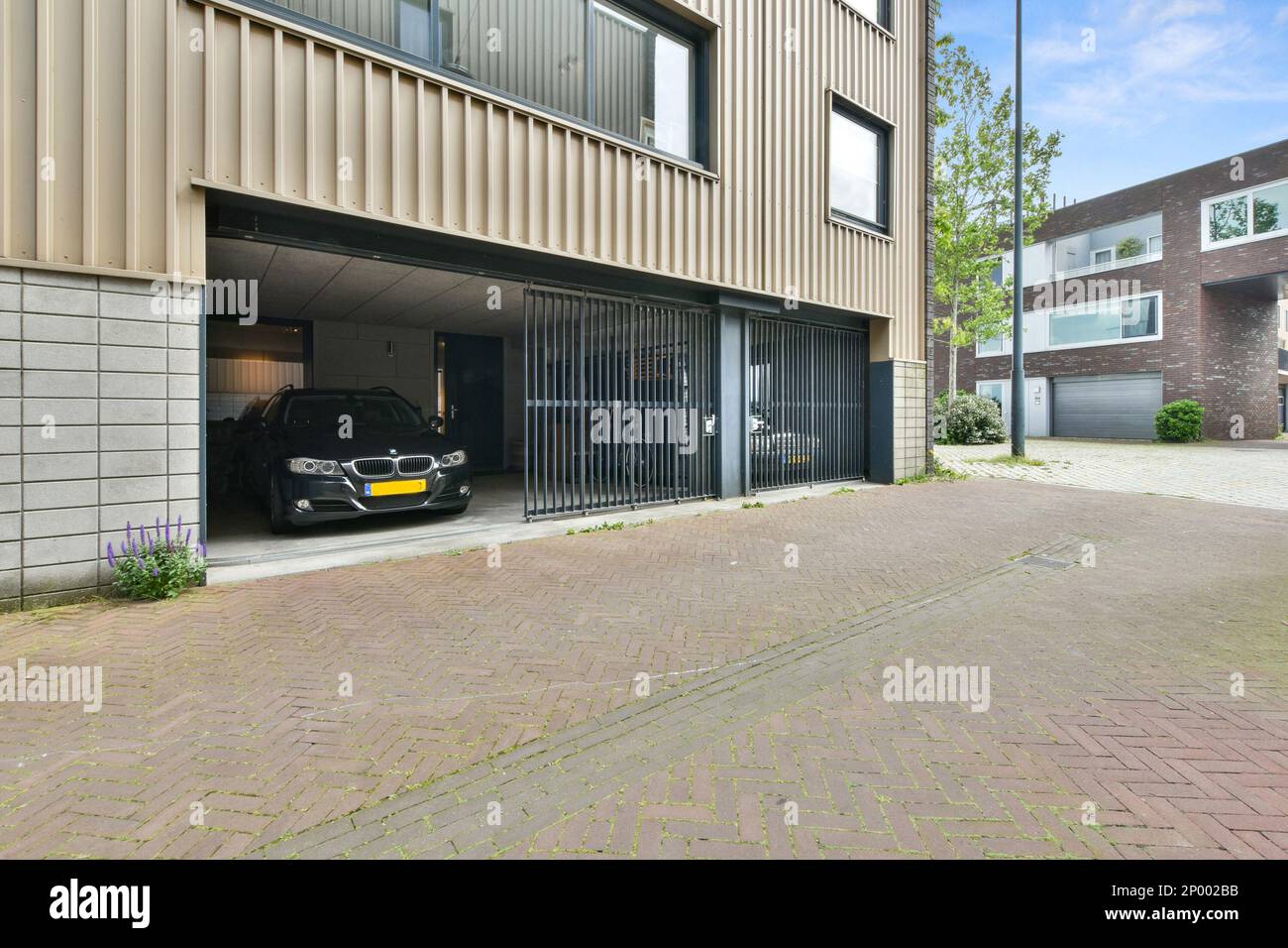 a car parked in front of a building with an open garage door on the ...