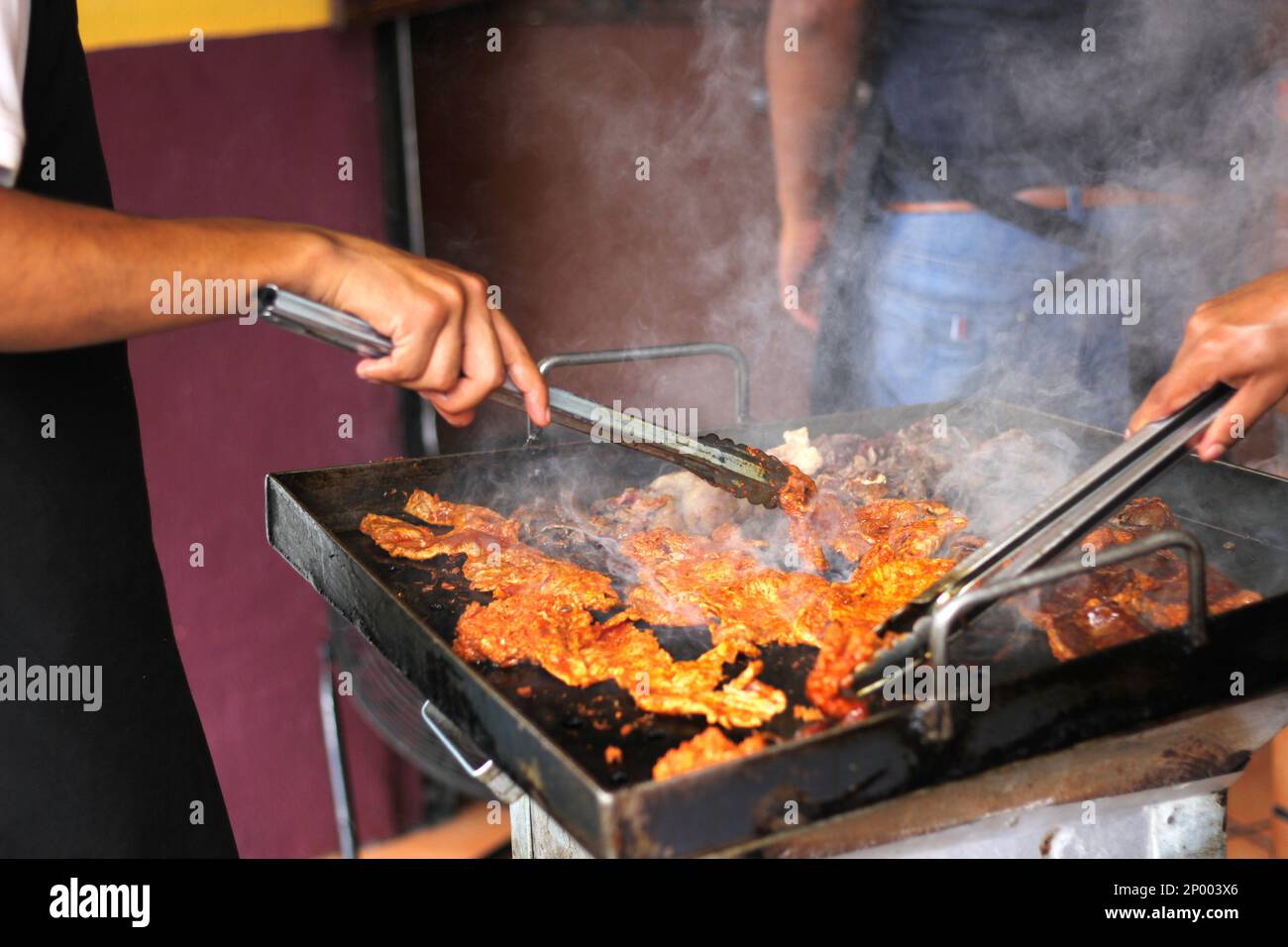 Male hands grilling chili meat on charcoal grill with cecina Stock ...