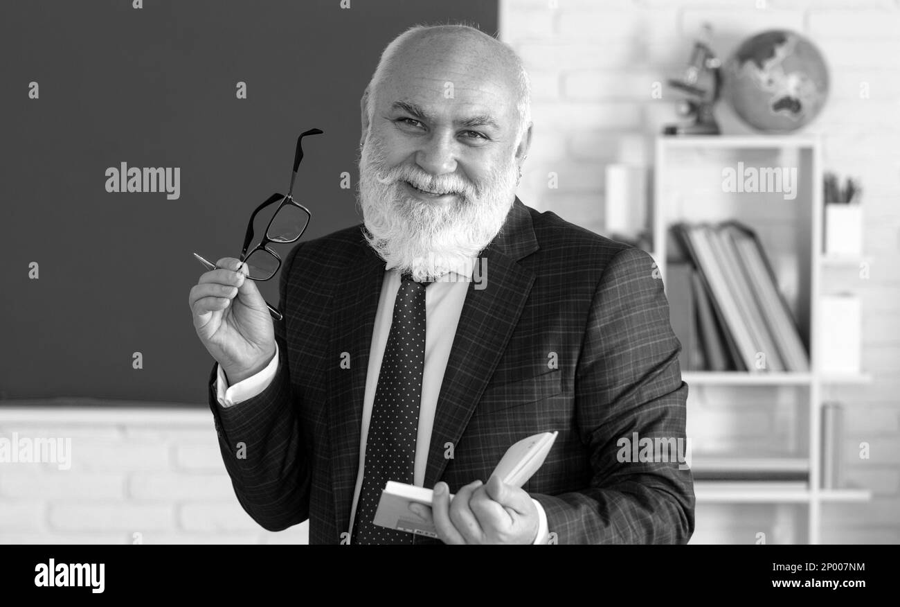 Grey hair funny happy smiling professor in empty lecture classroom ...