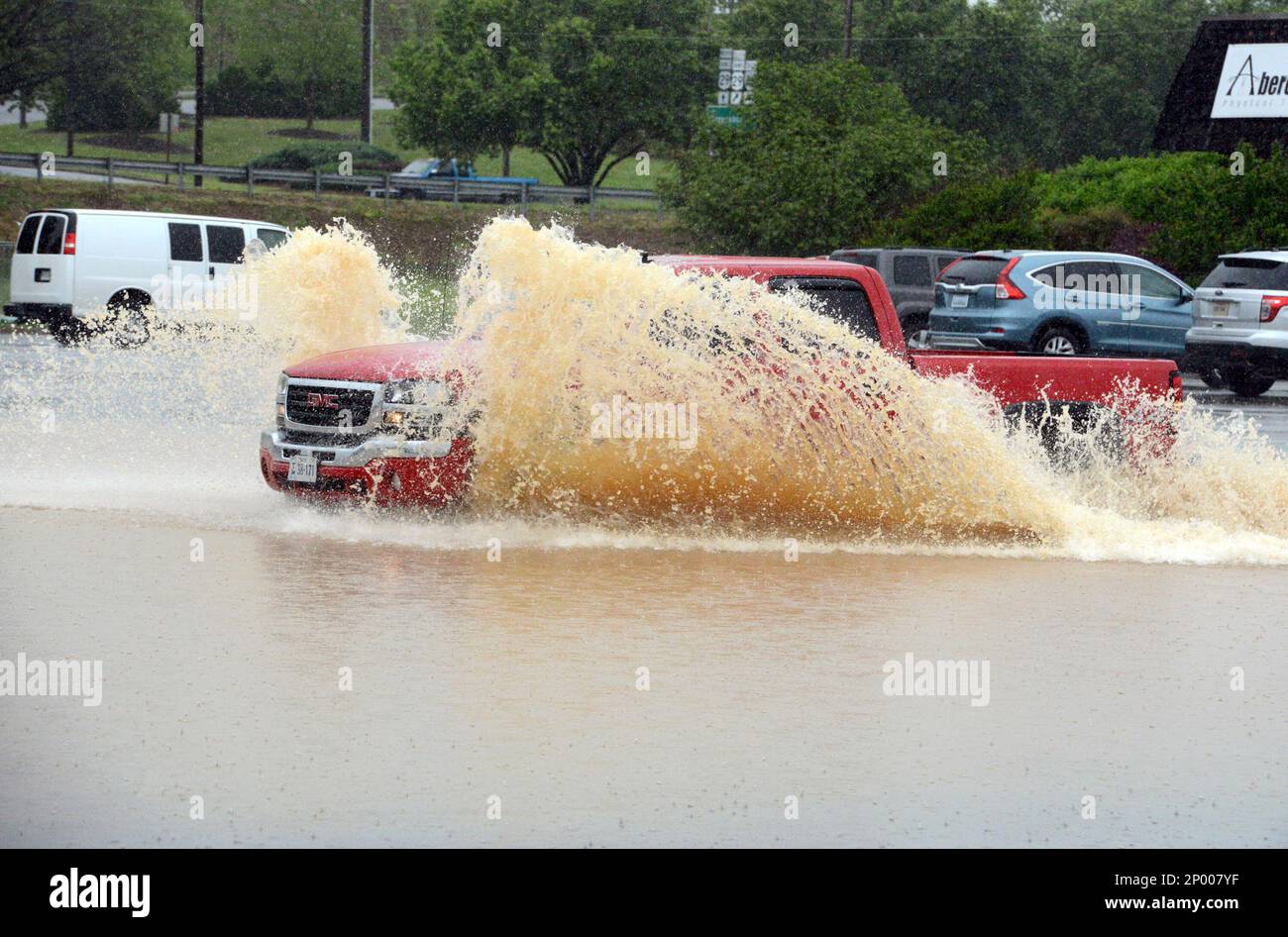 A driver chooses to go through water in front of Dan River Church ...