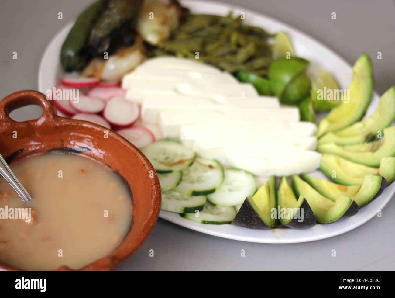 Plate of typical Mexican snack with cheese, nopales, chili peppers ...