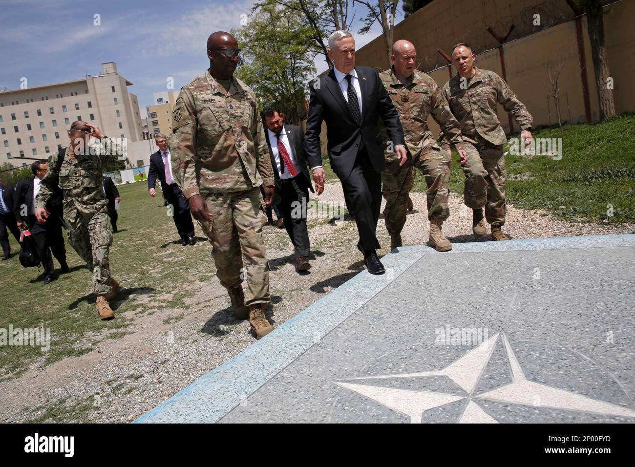 U.S. Defense Secretary James Mattis, third right, walks with U.S. Army ...