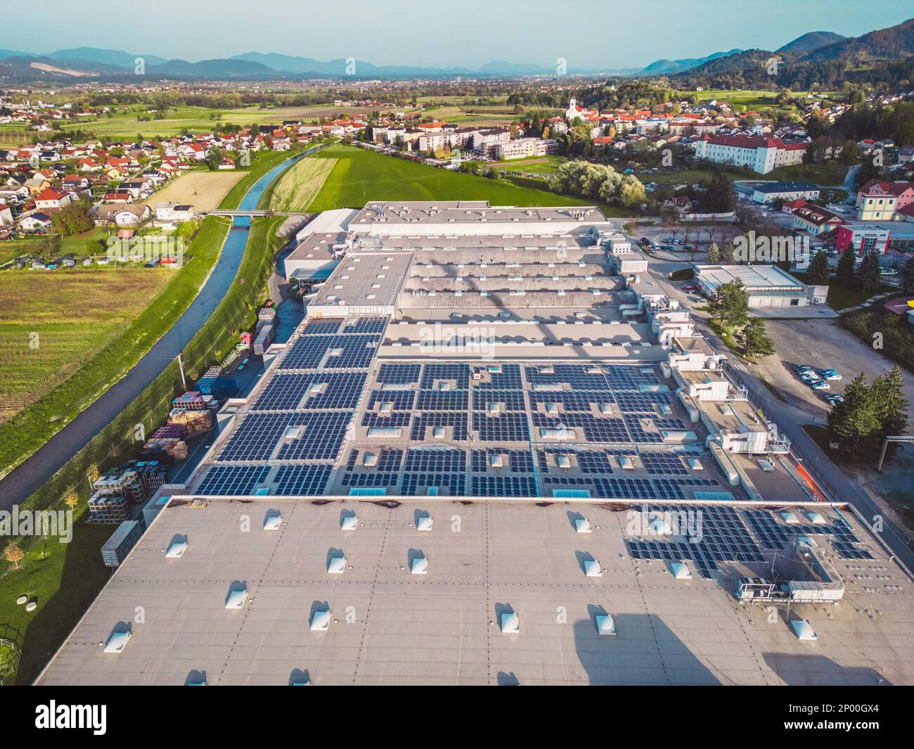 Aerial view of a large factory in the suburbs with solar panels ...