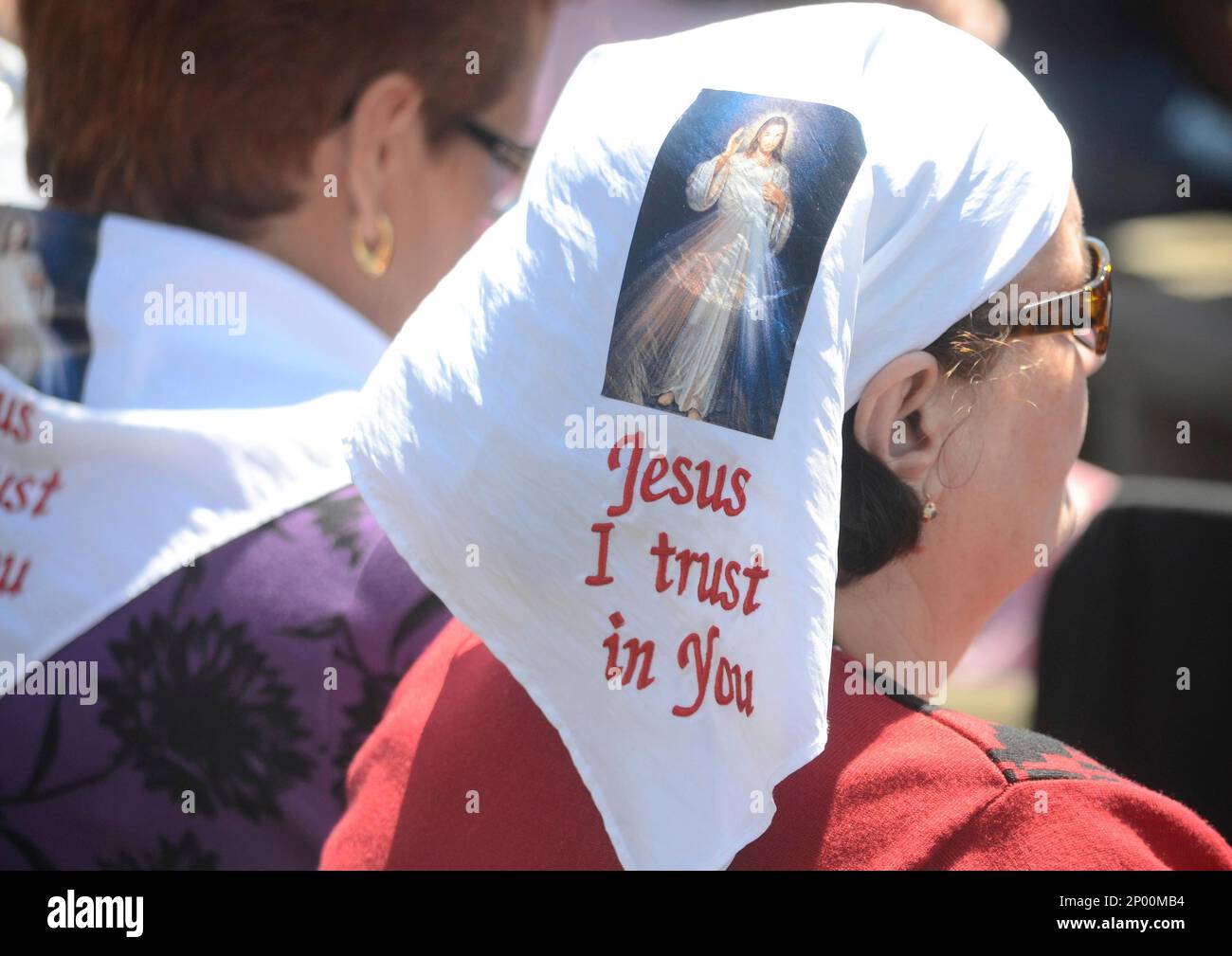 A couple of pilgrims wear scarves to protect them from the sun during ...