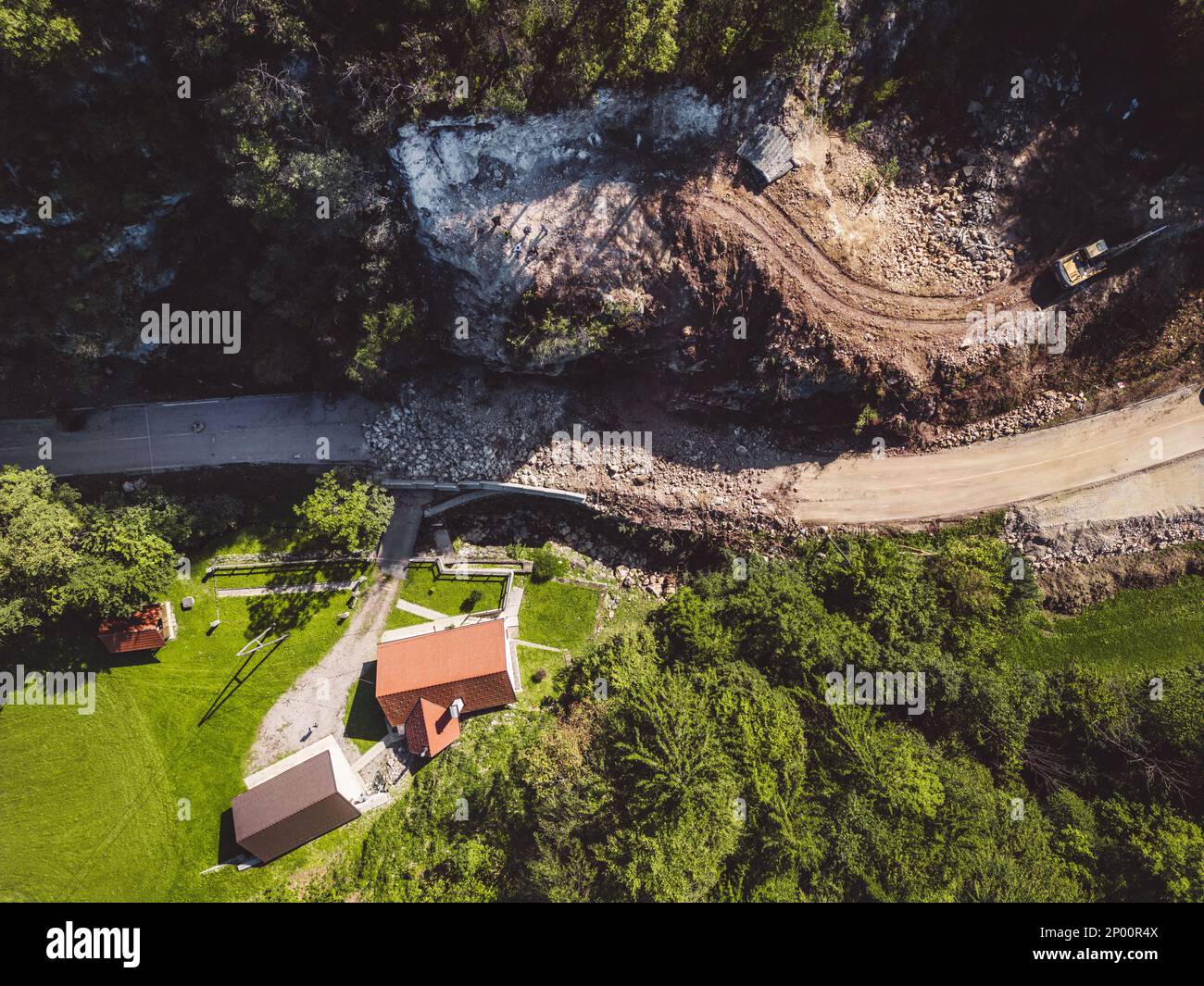 Aerial view of a landslide on a hill across the residential building ...