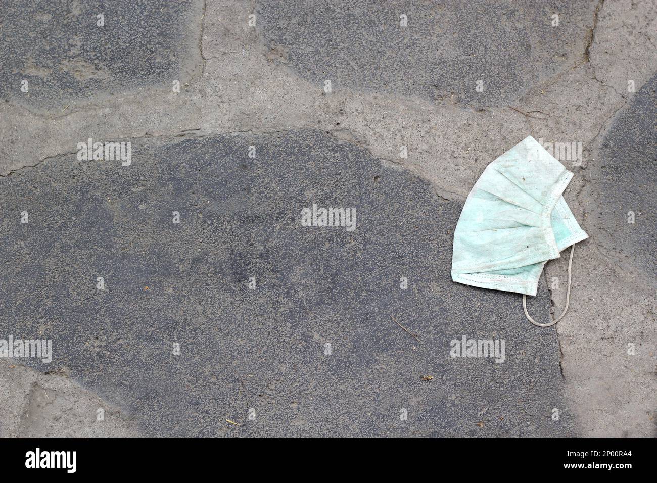 Used protection mask thrown on the street floor, sanitary and ...