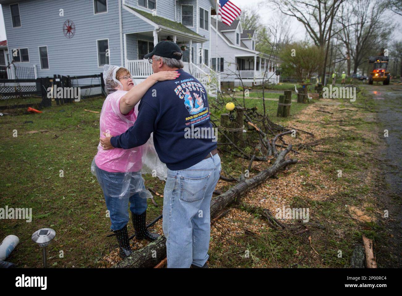 Mary Hatton gets a hug from neighbor Rich Estes as residents assess the ...