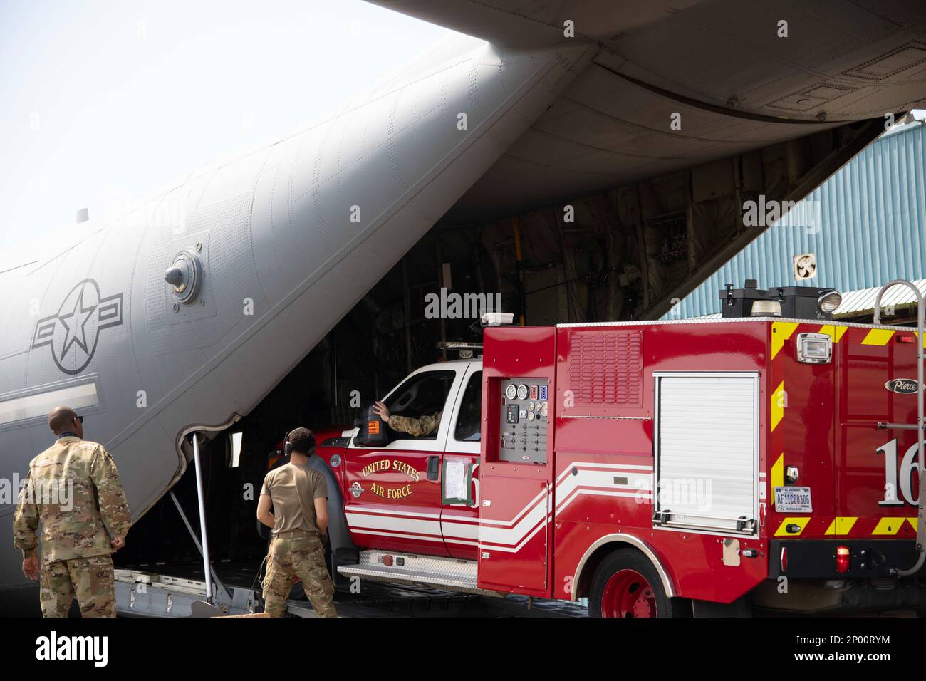 U.S. Airmen unload a P-34 Rapid Intervention Vehicle from a C-130J ...