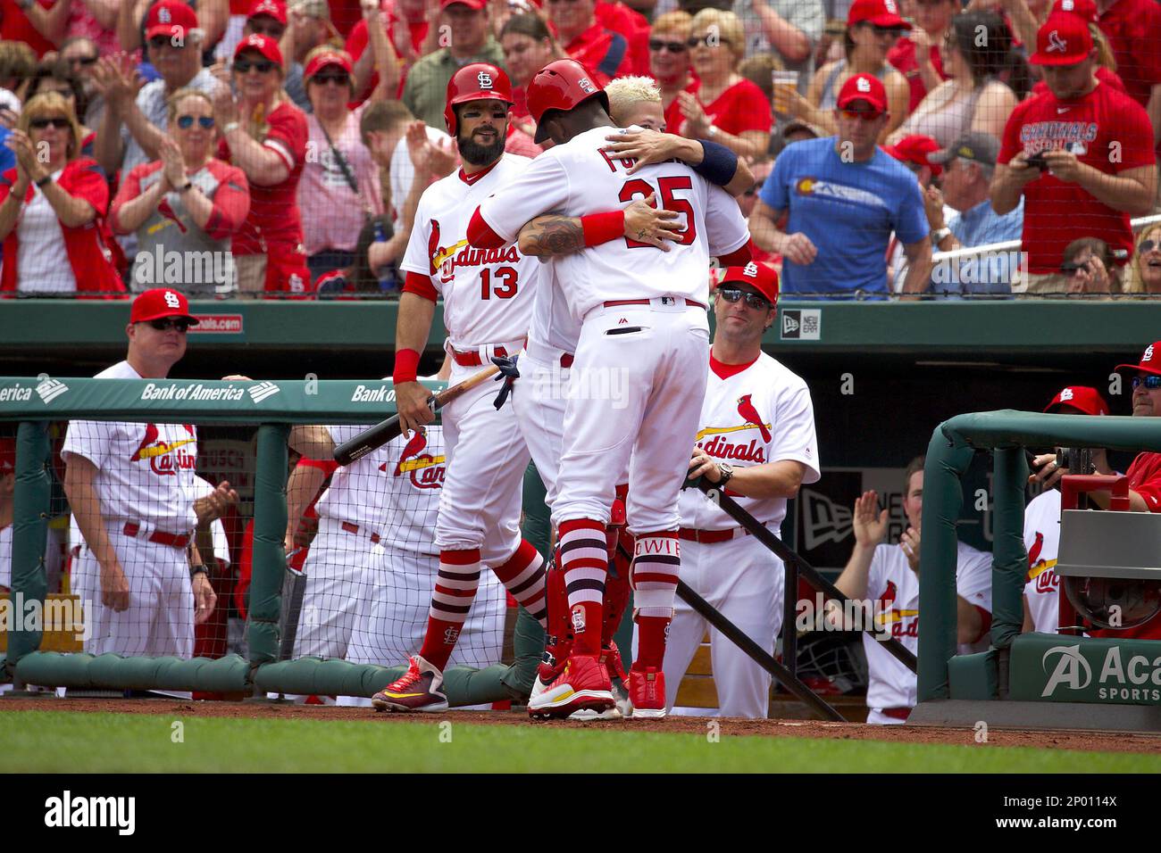 ST. LOUIS, MO - APRIL 19: St. Louis Cardinals catcher Yadier Molina (4) hugs St. Louis Cardinals ...