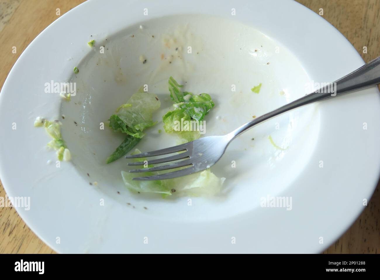 Empty plate after eating on table Stock Photo - Alamy