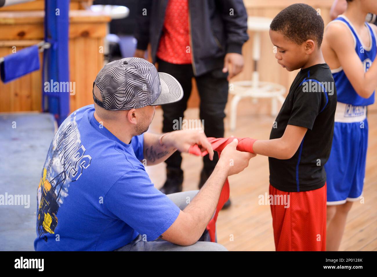 Seth, 8, gets his hands wrapped for what was his third boxing lesson at ...