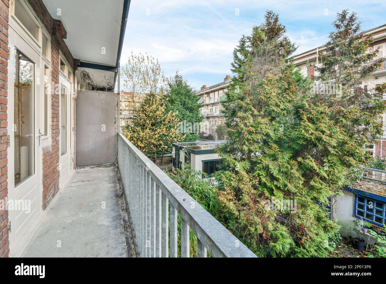 a balcony with trees and bushes in the fore - image was taken from an ...