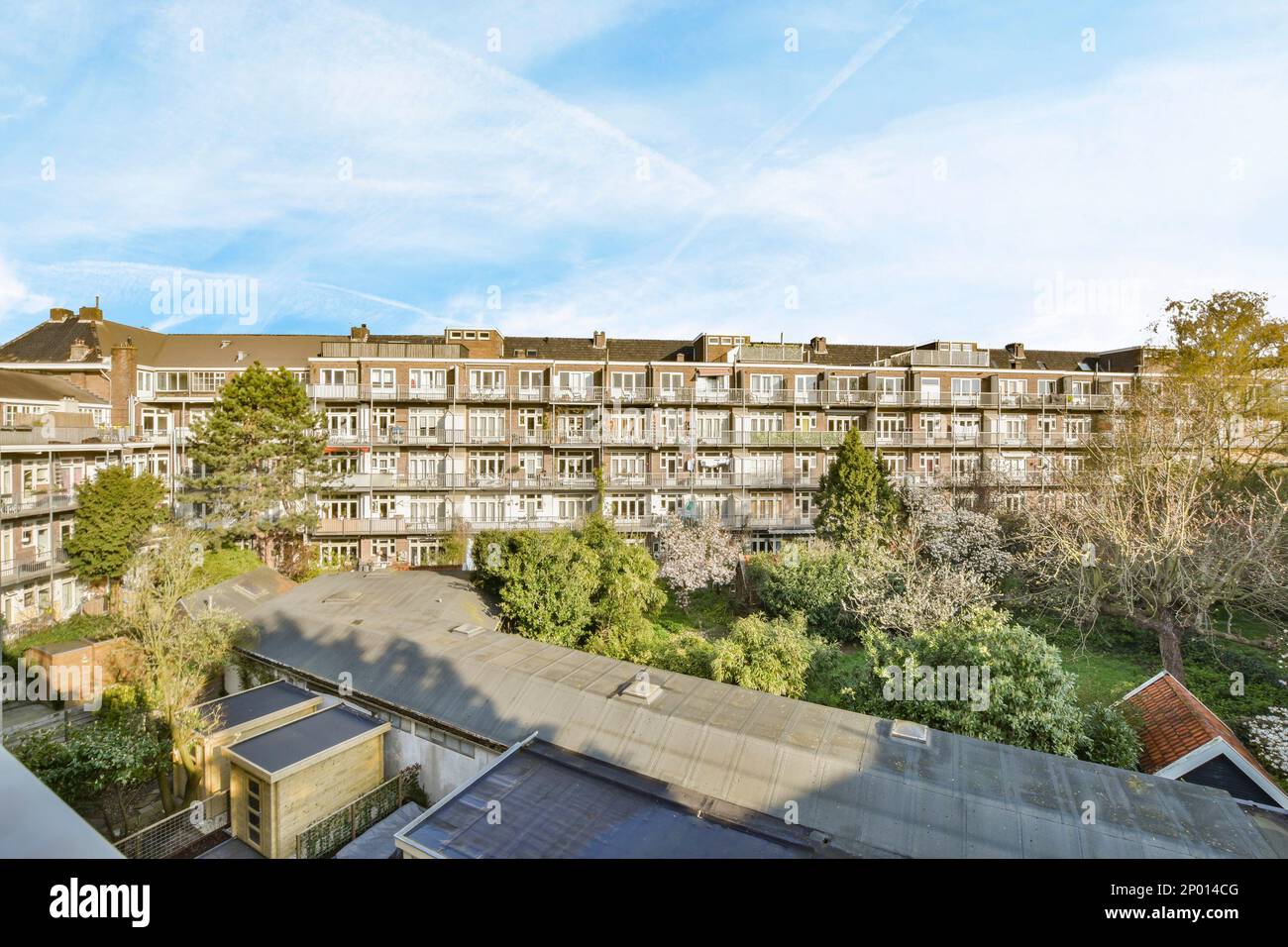 an apartment complex with trees and buildings in the foregrounded area ...