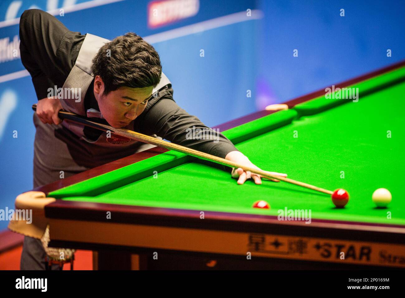 Yan Bingtao of China plays a shot to Shaun Murphy of England in their ...