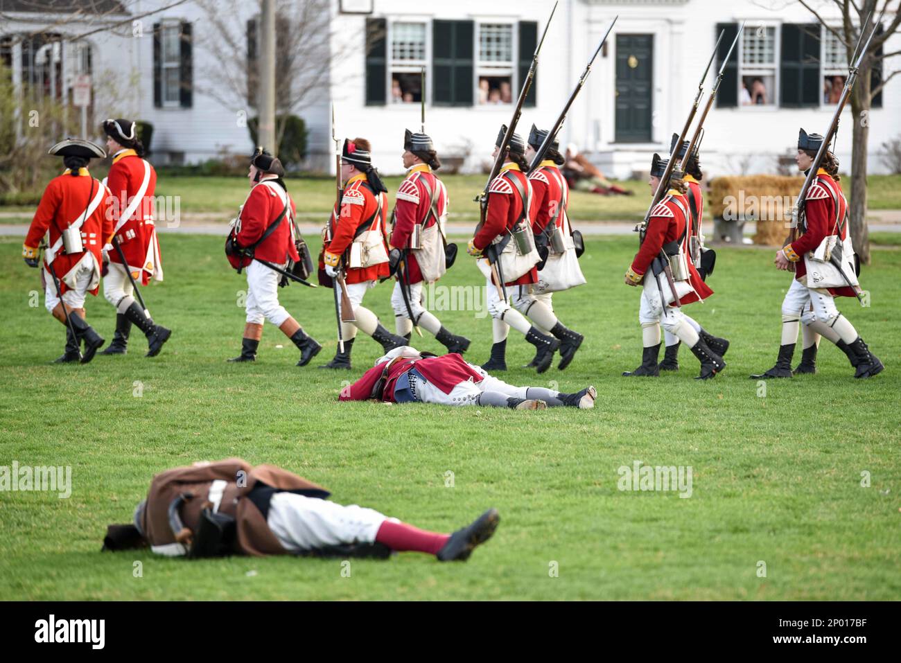 British re-enactors march past dead Colonial soldiers during the ...