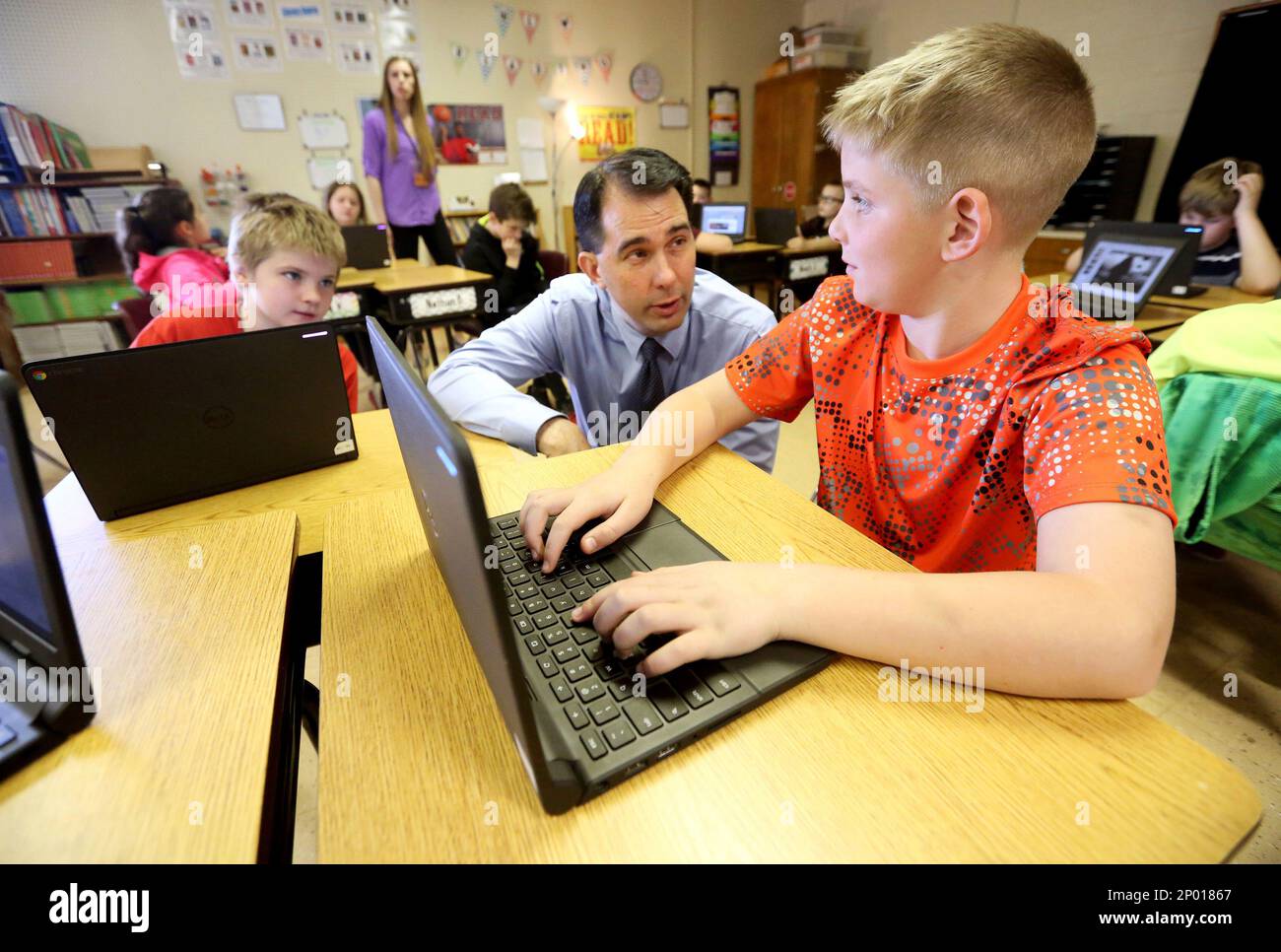 Wisconsin Gov. Scott Walker speaks with fourth-grader Reese Ammon, far ...
