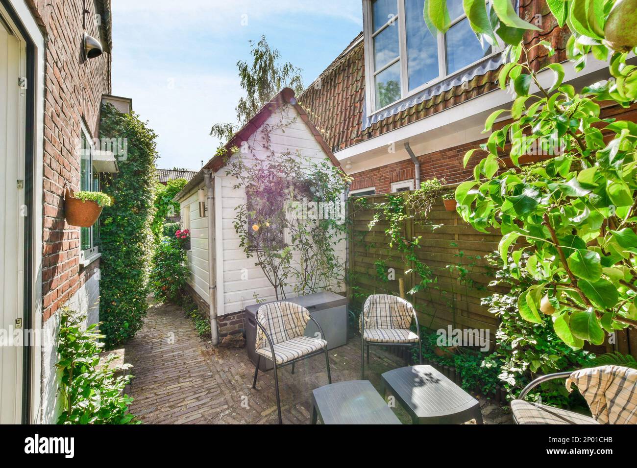 an outside area with tables and chairs in the middle part of the yard ...