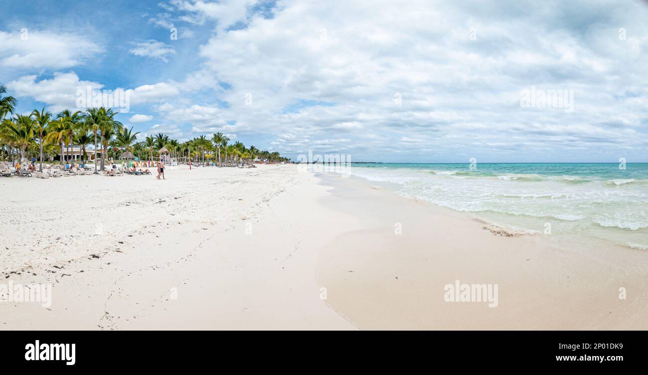 Panorama over a tropical beach taken from the water during the day with ...