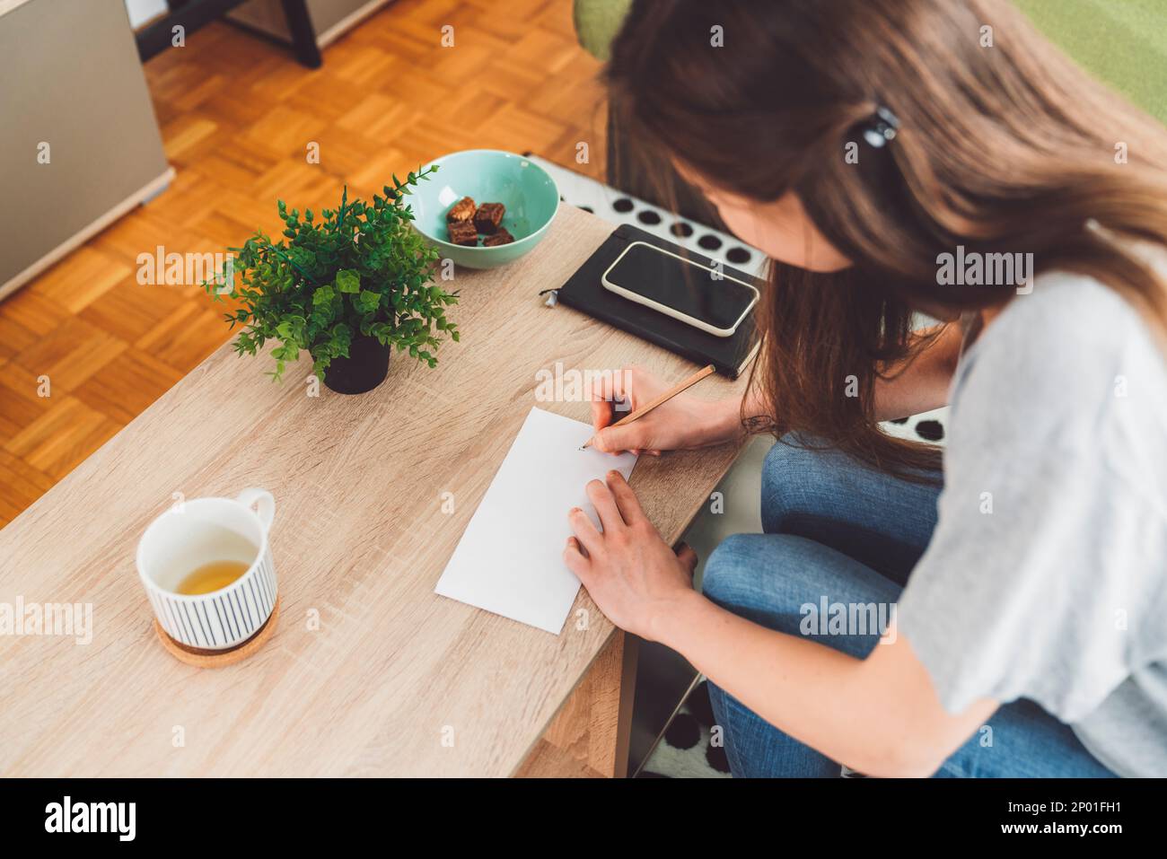Top down view woman writing the address on the letter Stock Photo - Alamy
