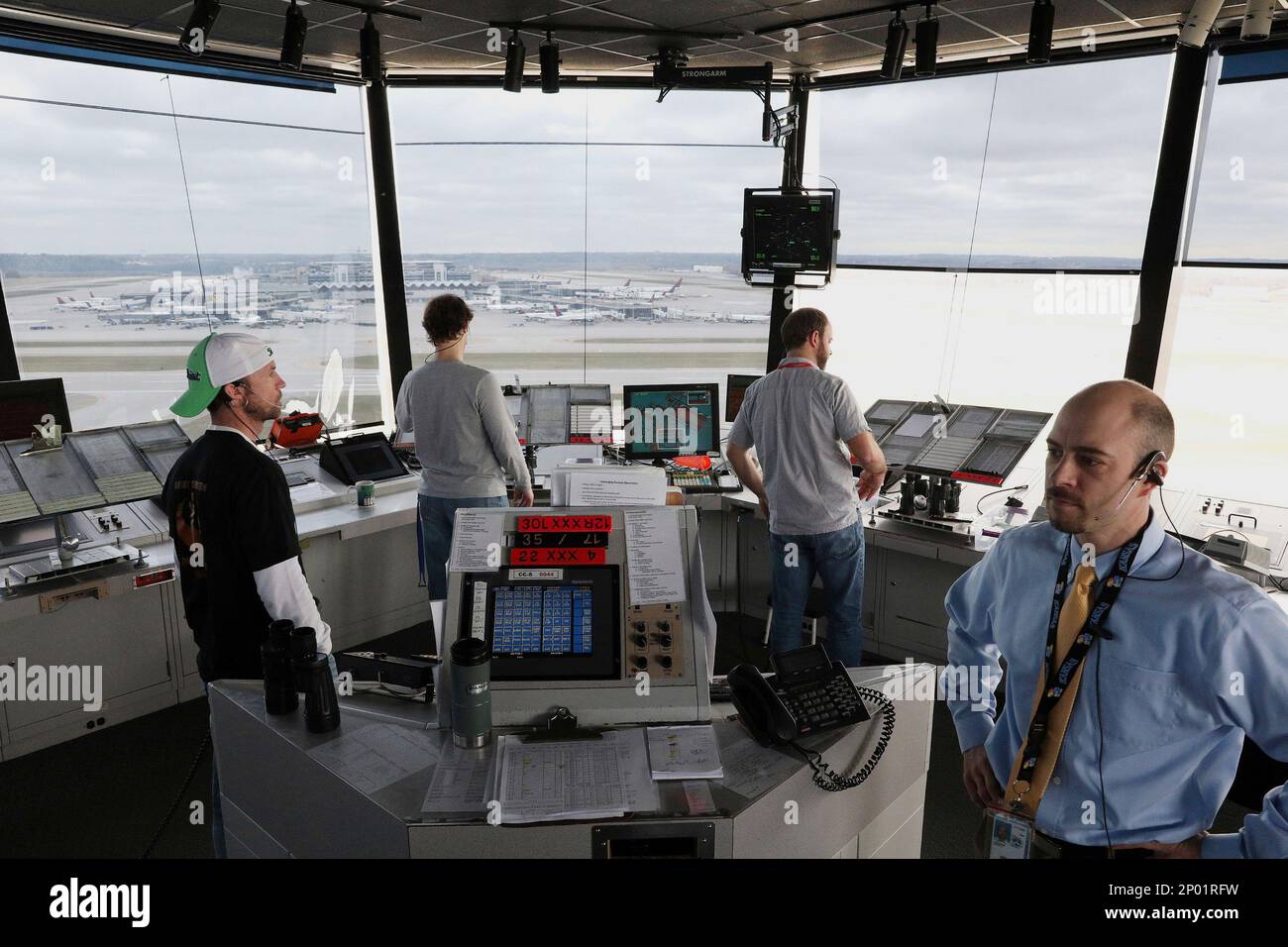 Air traffic controllers including Justin Langerud, right, work from the ...