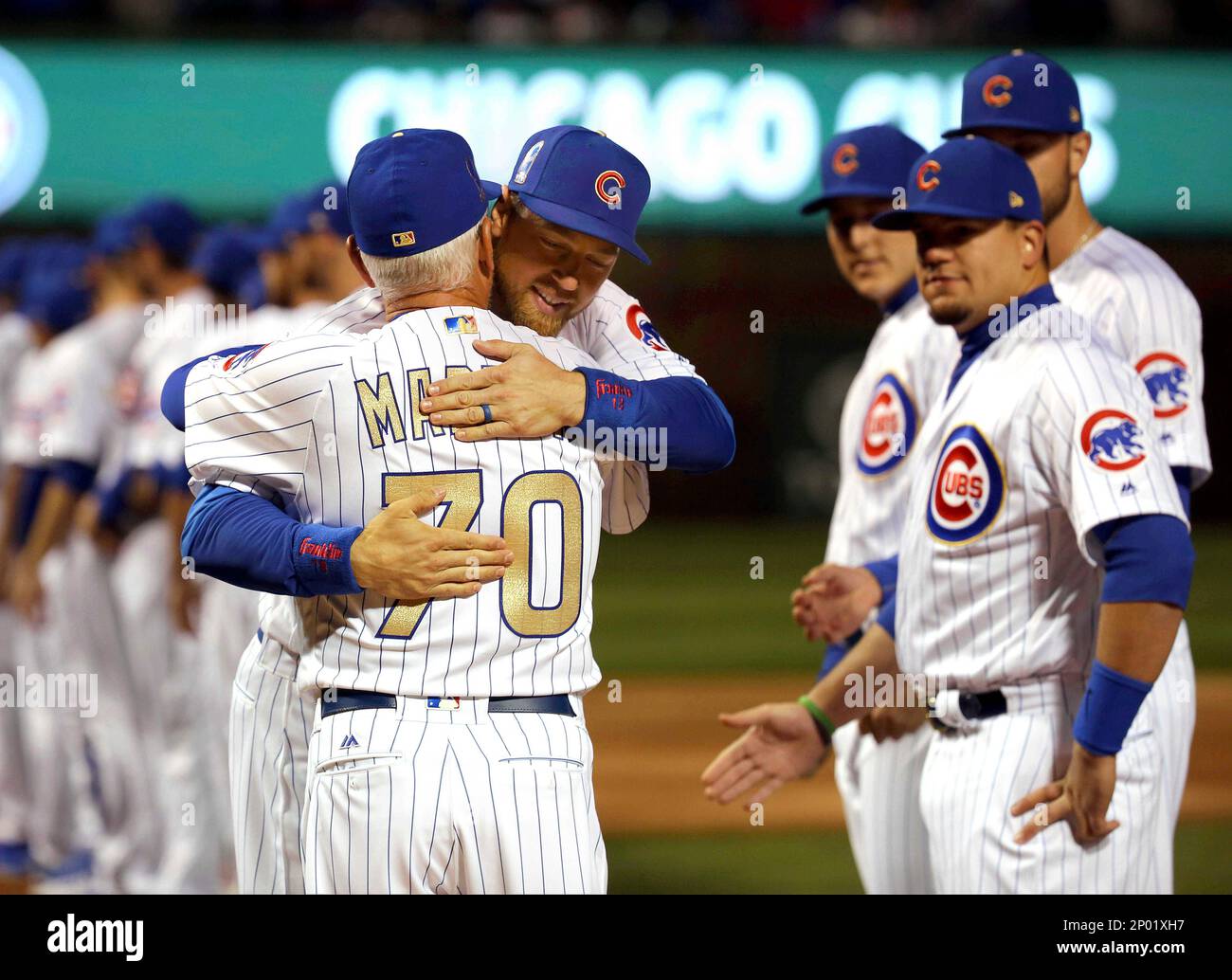 Chicago Cubs' Ben Zobrist embraces manager Joe Maddon during ceremonies ...