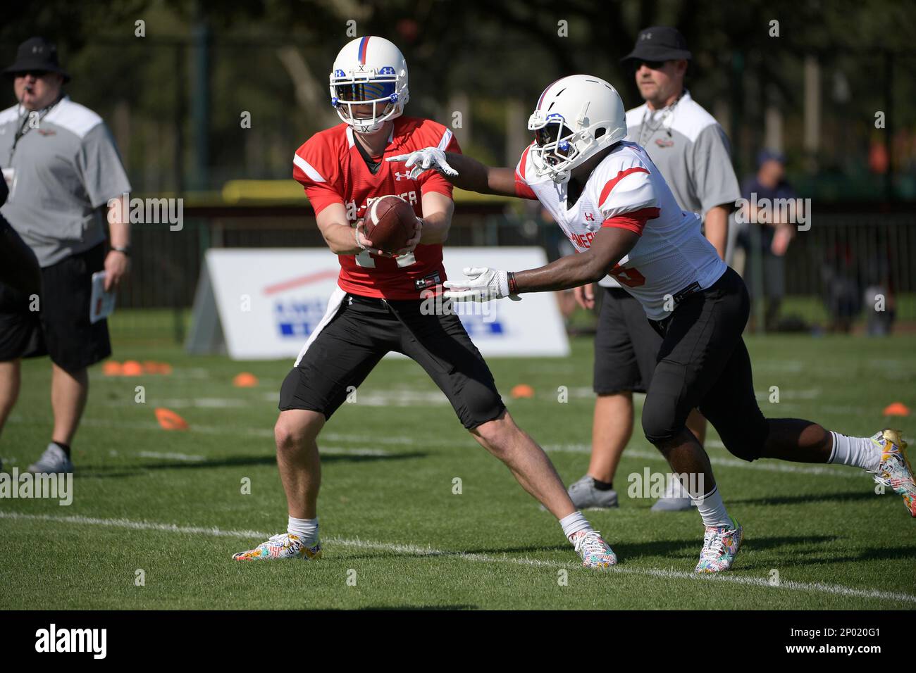 Team Highlight quarterback Ryan Kelley, left, hands the ball off to ...